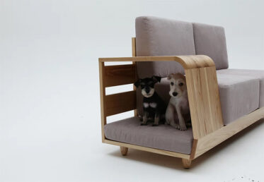 This Couch Has A Dog Bed Built-In To The Wooden Armrest