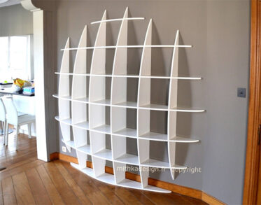 These 3D Sphere Bookshelves Look Like They're Emerging From Within The Wall