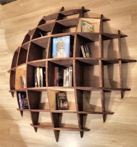 These 3D Sphere Bookshelves Look Like They're Emerging From Within The Wall